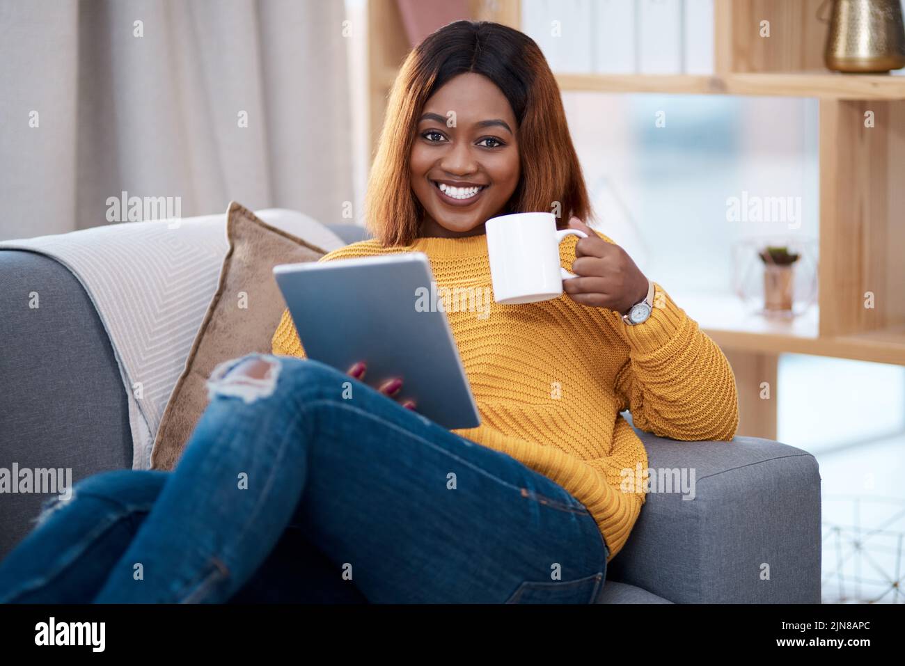 Home is my happy place. an attractive young woman using a digital ...