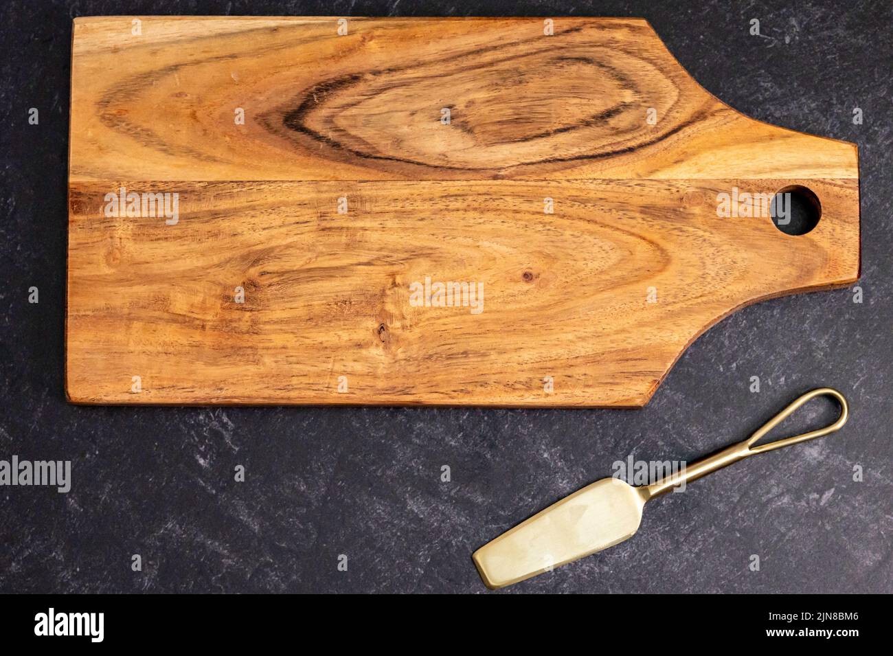The top view of a rectangular wooden chopping board on the gray surface ...
