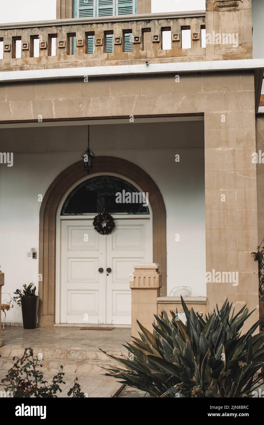 Modern building with columns, balcony and tropical plants in Larnaca ...