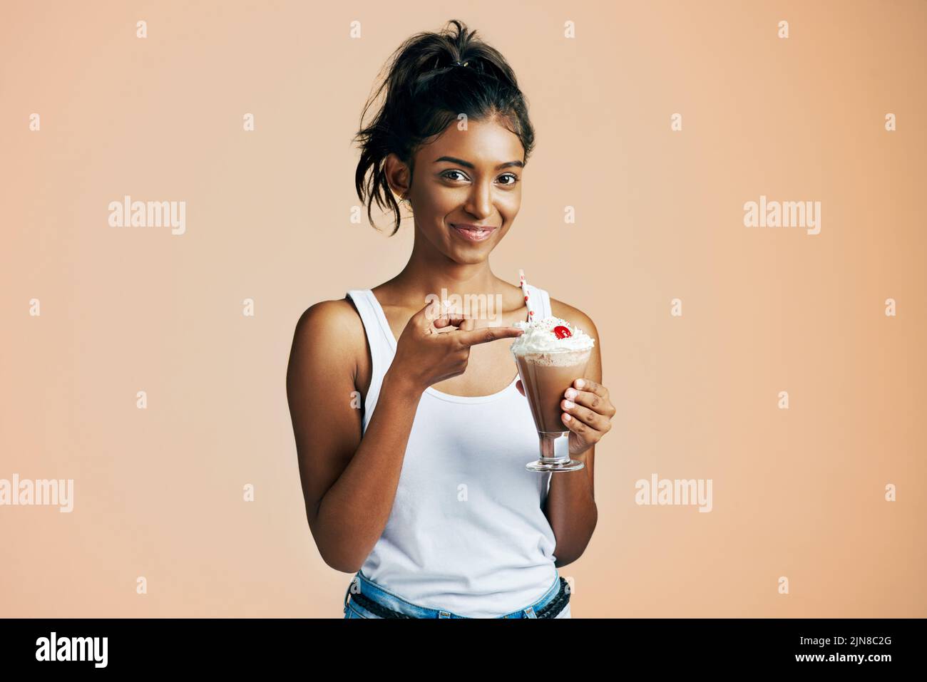 Enjoying a glass of goodness. Studio portrait of a beautiful young ...