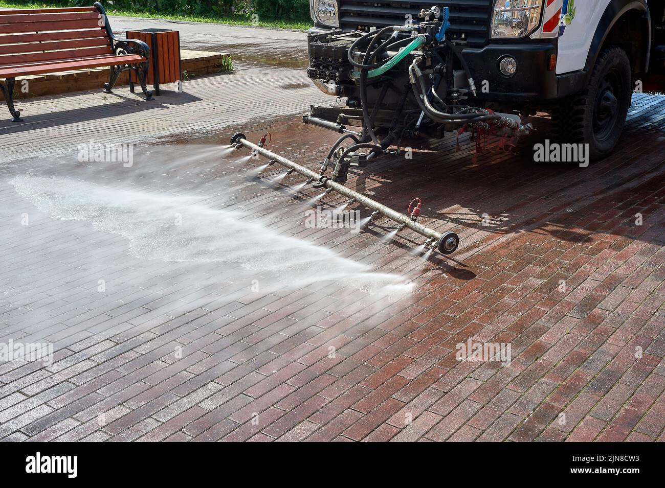 A special machine washes city paths and roads with water Stock Photo ...
