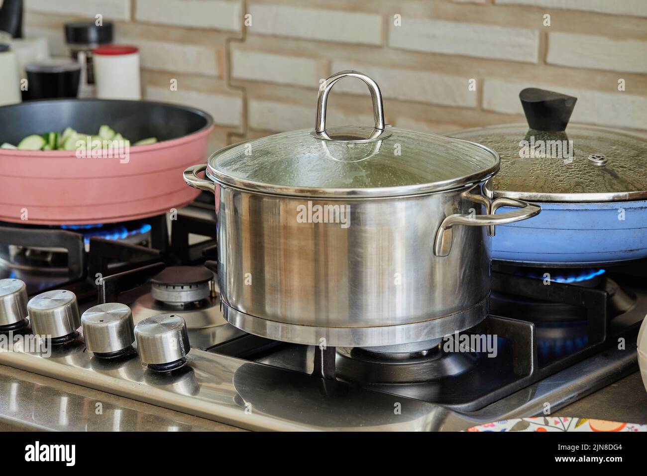 Pots with cooking food in the kitchen on gas stove Stock Photo - Alamy