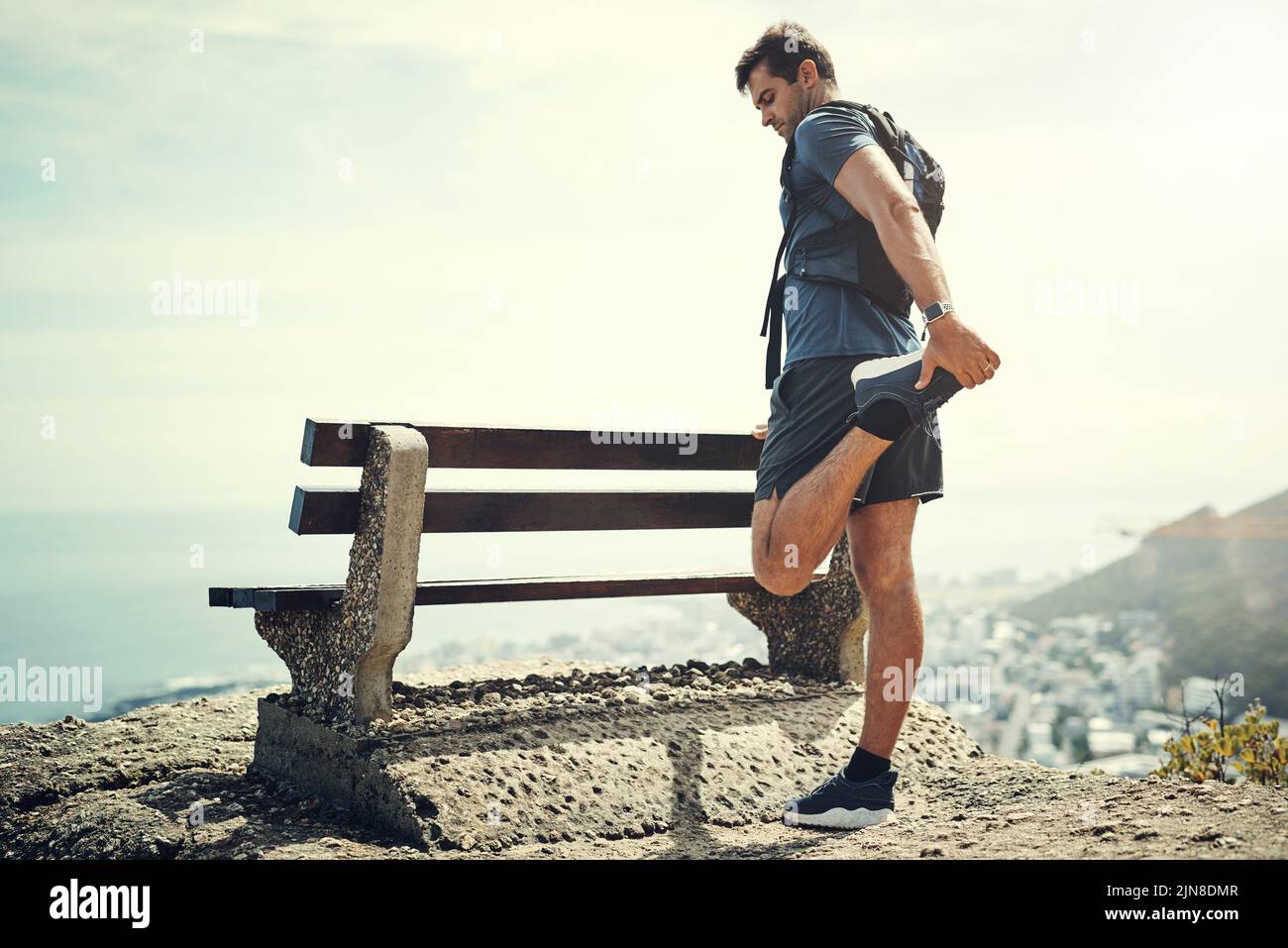 Getting his legs ready for a hike. Rearview shot of a handsome young ...