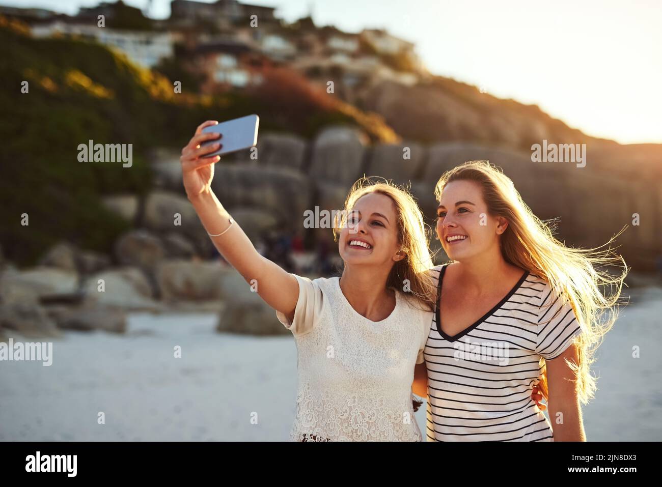 Selfies are a must. two friends taking a selfie while spending the day ...
