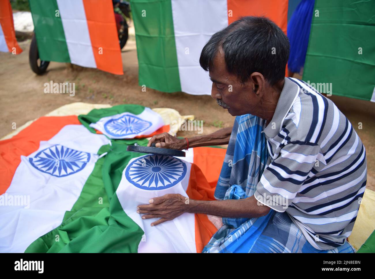 Workers prepare Indian national flags at a workshop ahead of India’s ...