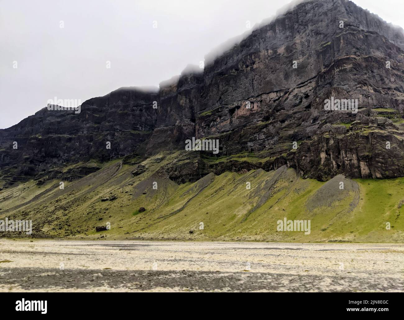 A scenic landscape with dense clouds soaring over steep cliffs Stock ...