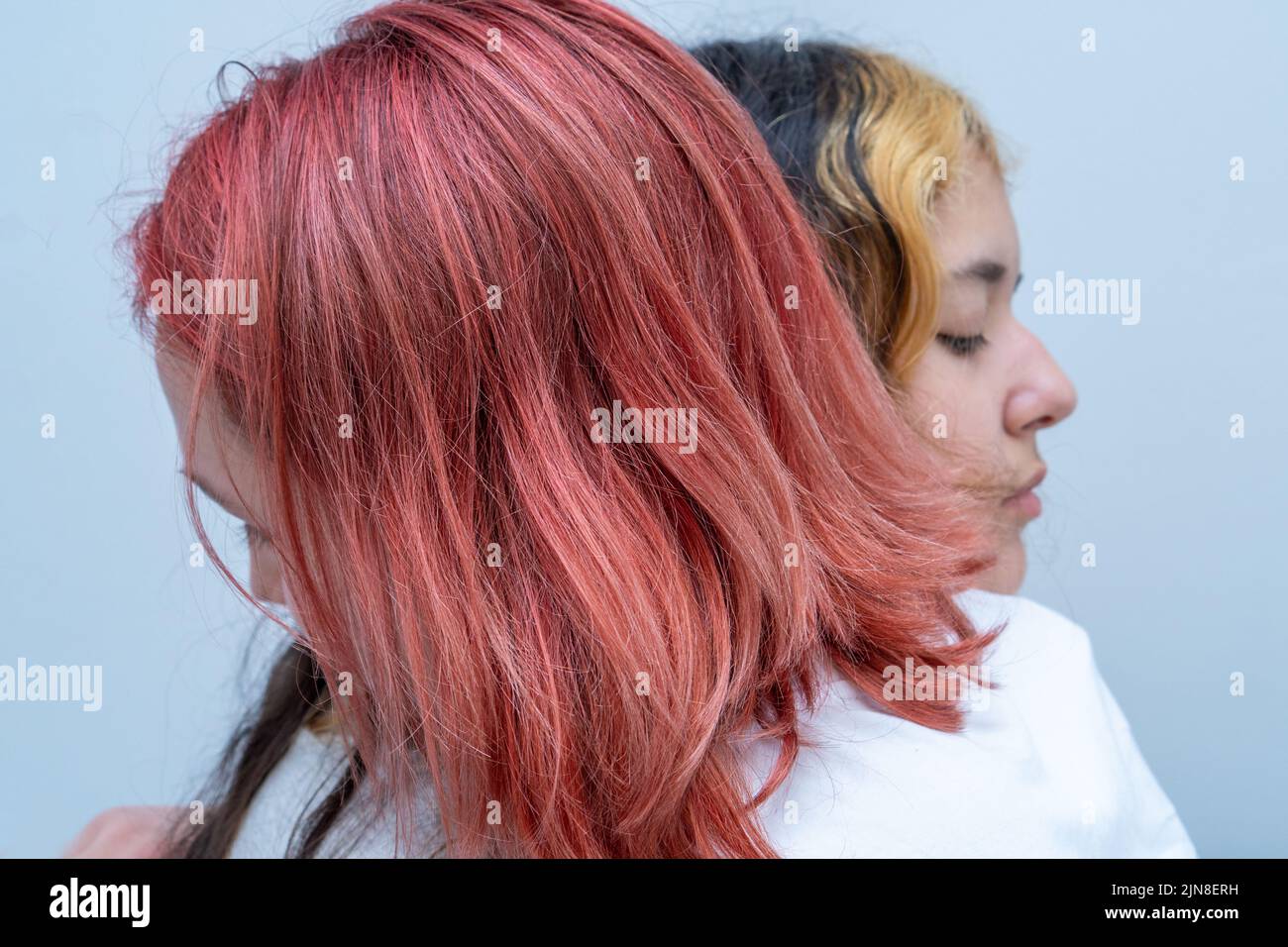 Tclose up portrait Two teenage girls are hugging and looking into the ...