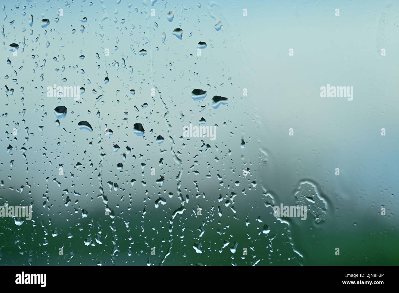 Rain drops on window, rainy day in a close up full frame background ...