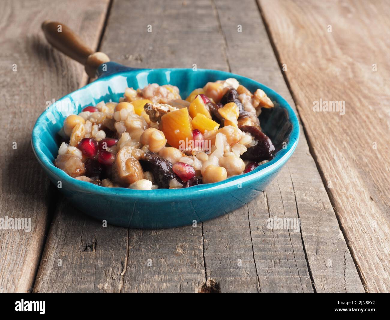 Tasty Noah s ark pudding in a creamic bowl , healthy muesli on a rustic ...