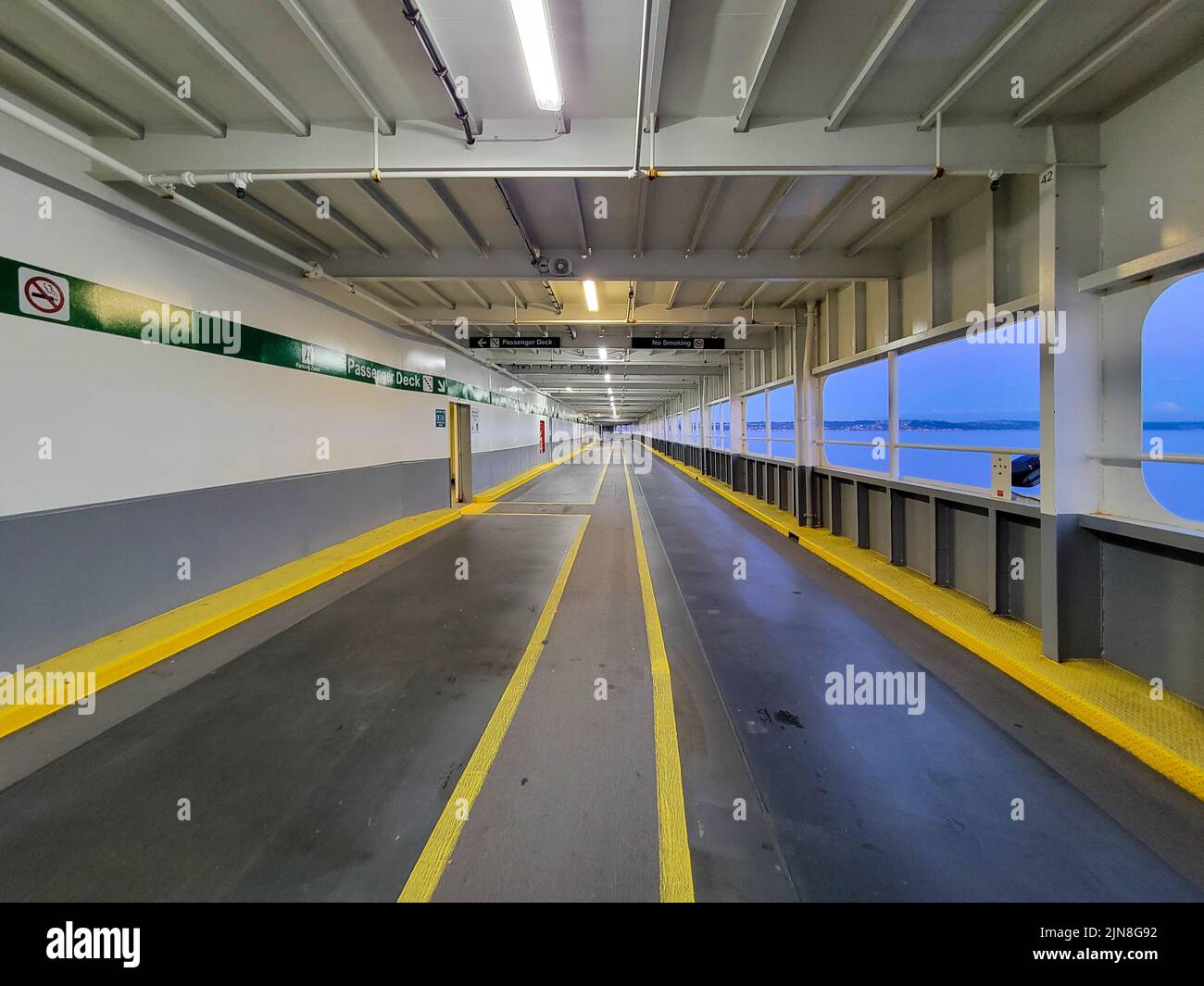 An empty car deck on a ferry with a sea view from the left side Stock ...