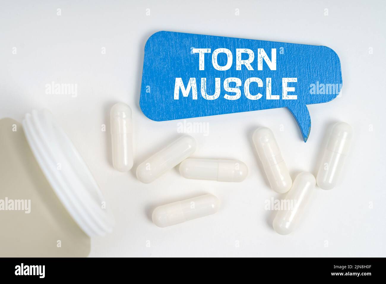 Medicine and health concept. On the table are pills and a blue sign ...