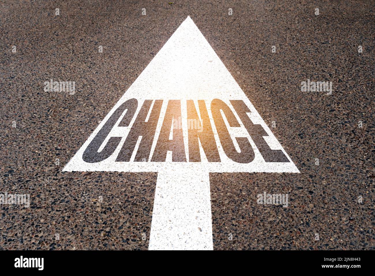 Business concept. On the asphalt road markings an arrow with the ...