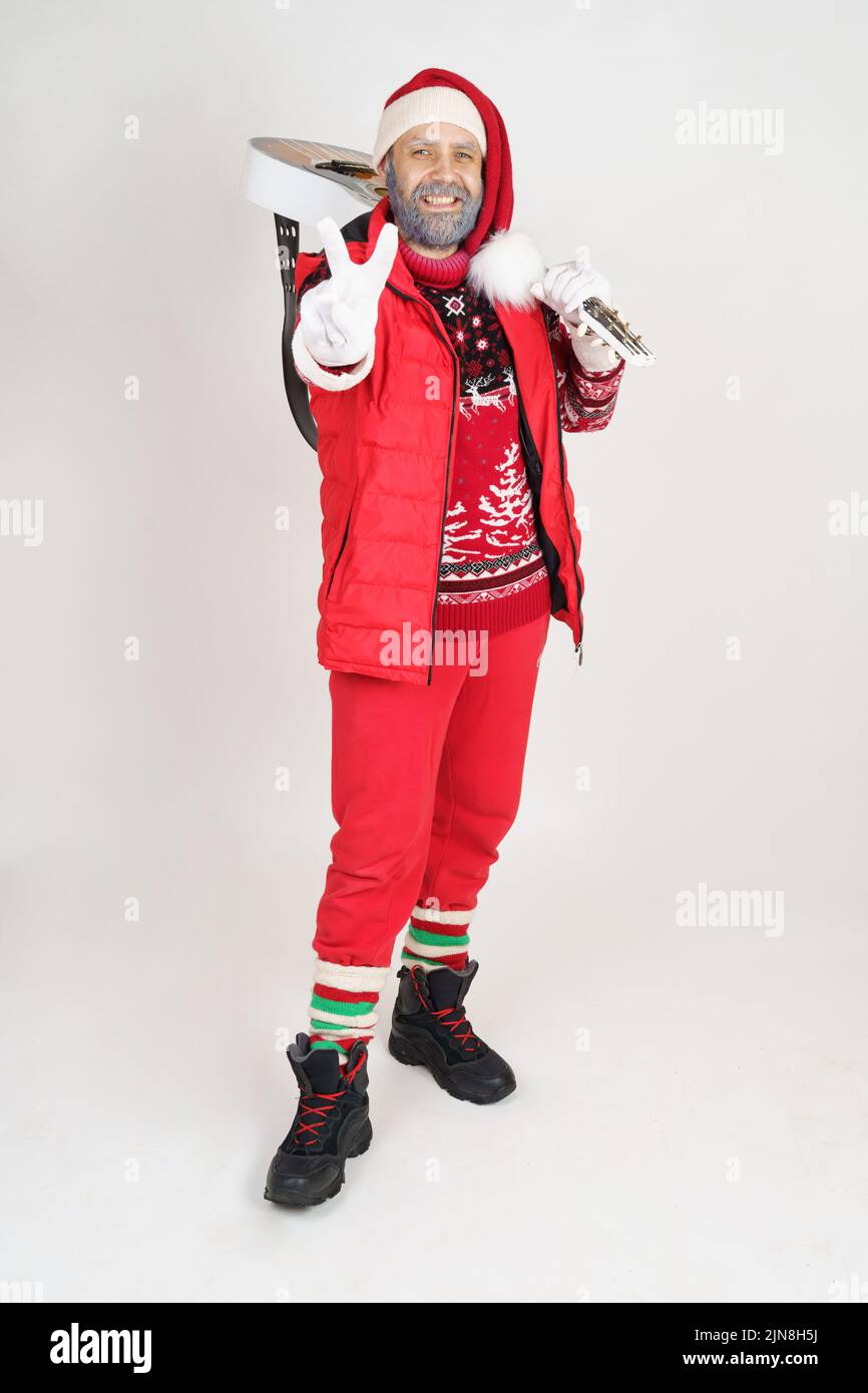New Year and Christmas concept. Santa Claus holds a guitar and shows ...