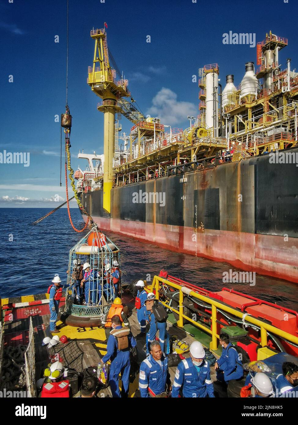crew transfer by personal transfer basket from fast crew boat to FPSO ...
