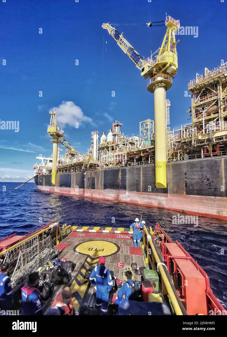 Fast crew boat aproaching FPSO in 500 meter zone for crew transfer ...