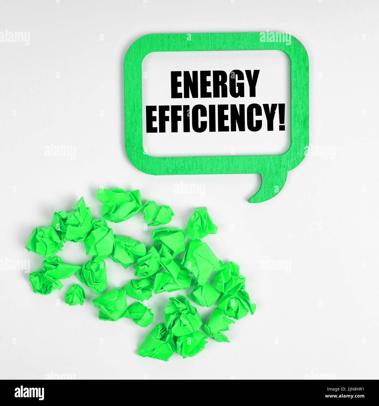 Ecology concept. On a white background, green crumpled pieces of paper ...