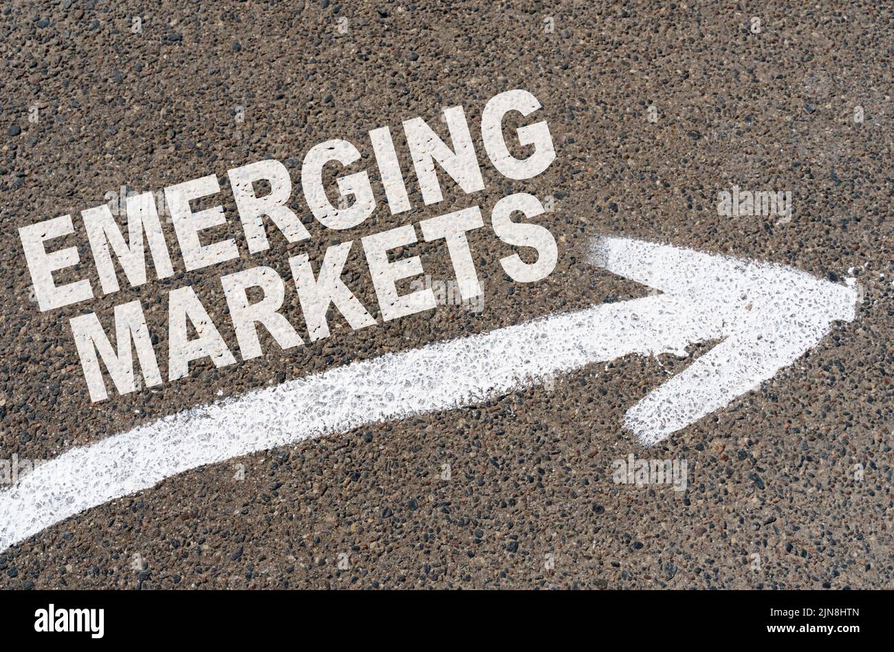 Business concept. On the asphalt road markings an arrow with the ...