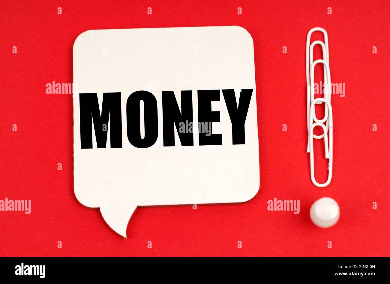 Business concept. On a red background, paper clips are an exclamation ...