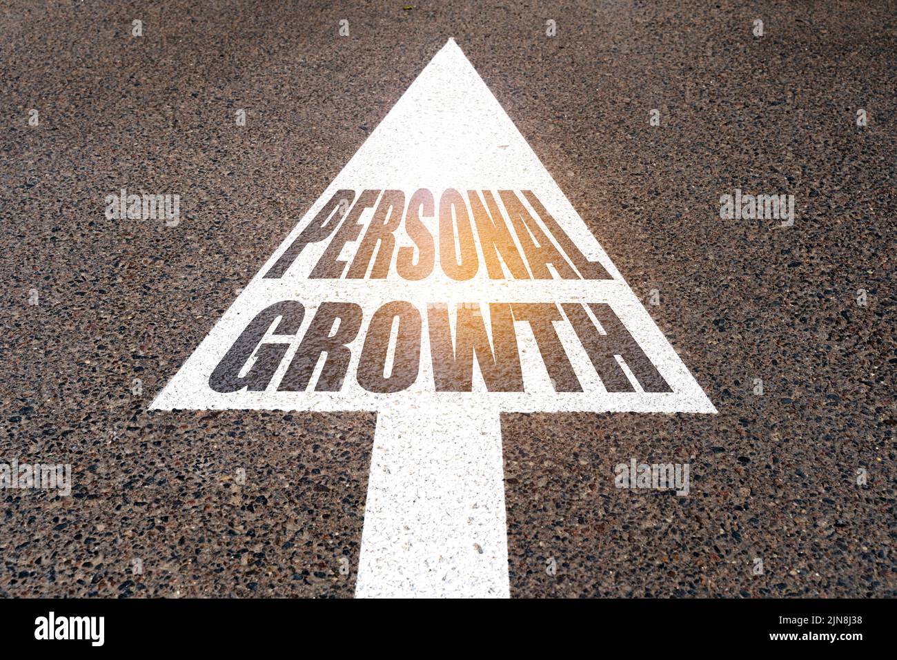 Business concept. On the asphalt road markings an arrow with the ...