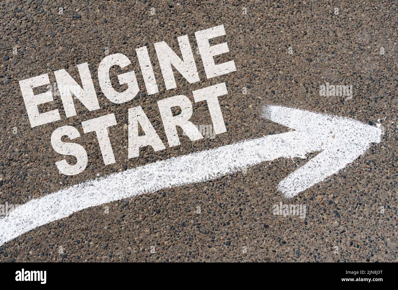 Business concept. On the asphalt road markings an arrow with the ...