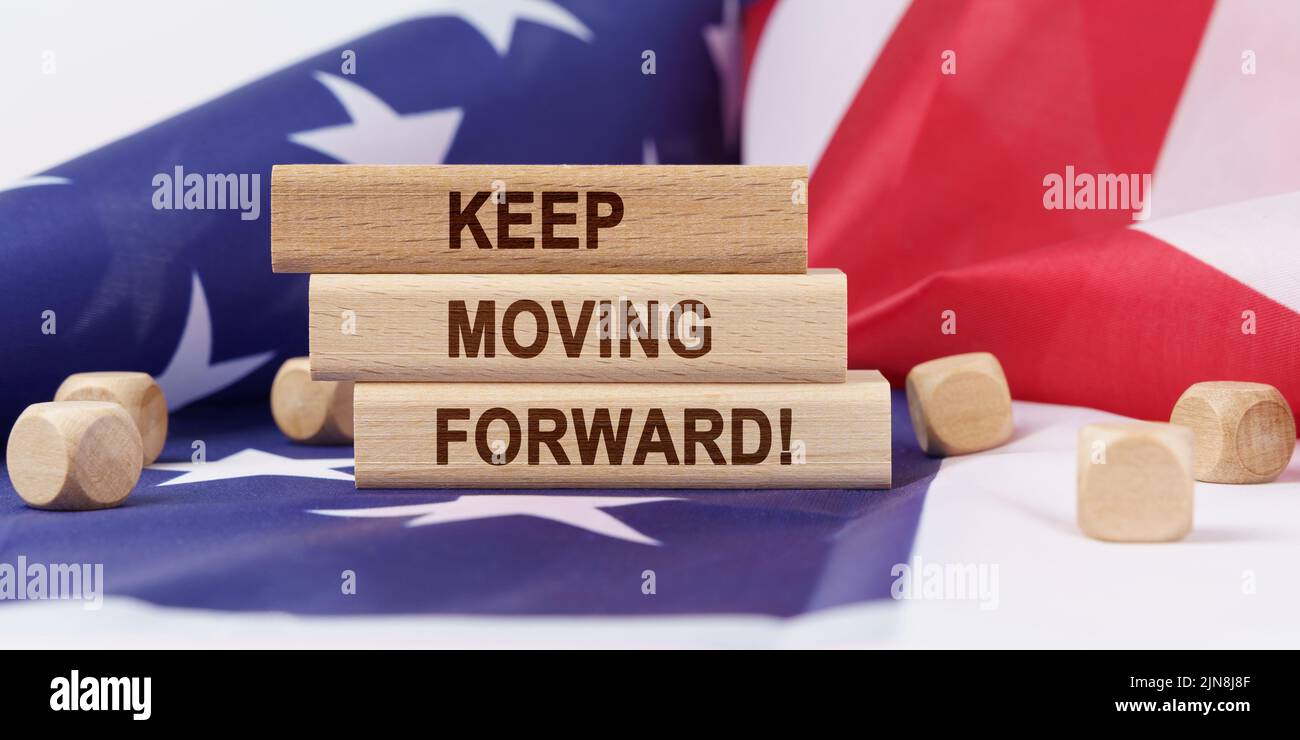 Business concept. The American flag has wooden cubes and plaques that ...