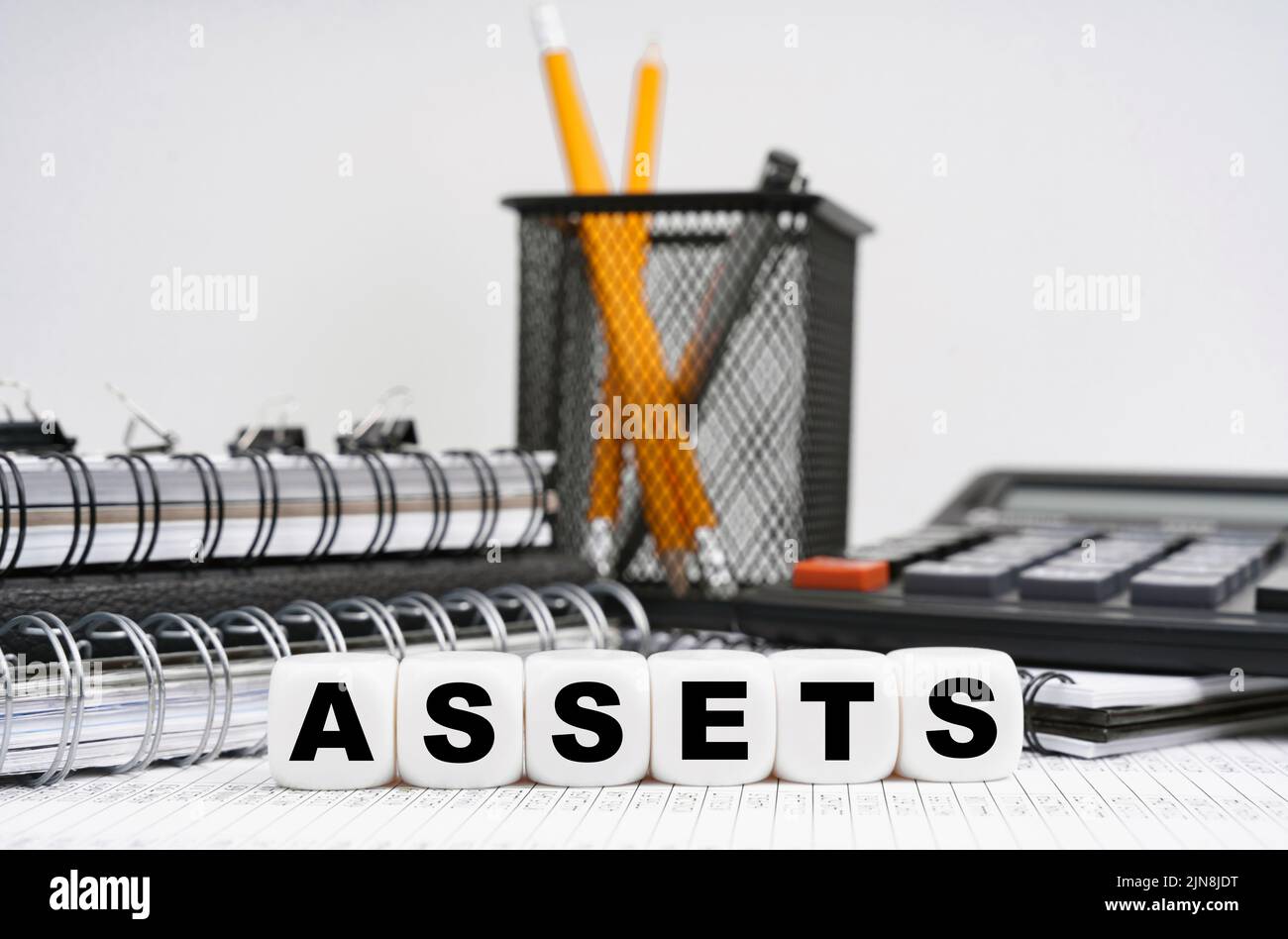 Business and finance concept. On the table, among office objects, cubes ...