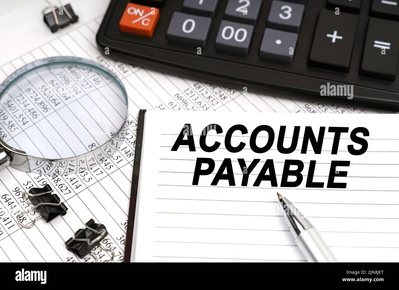 Business concept. On the table is a magnifying glass, a calculator, a ...