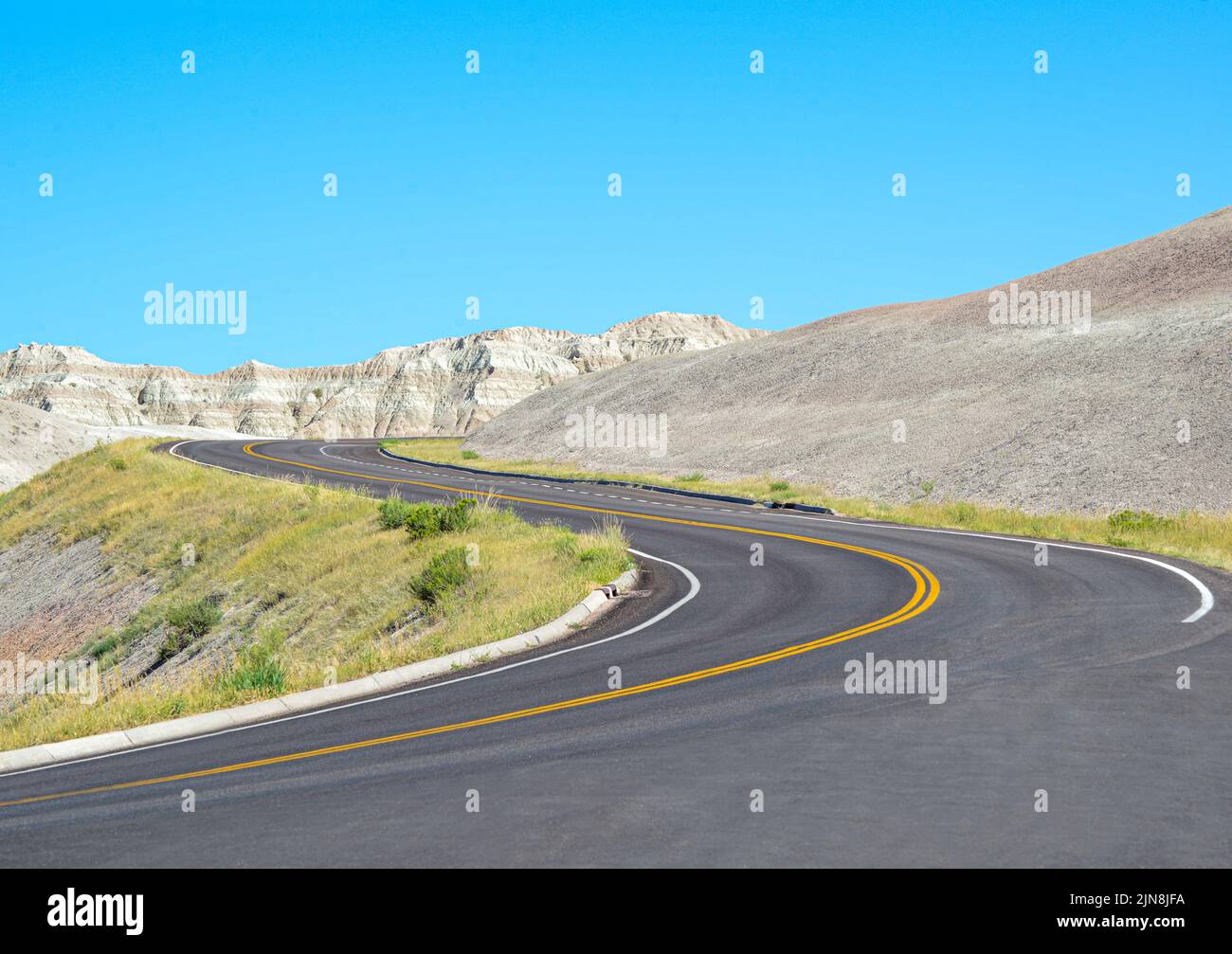 Isolated road through Badlands National Park in South Dakota Stock ...