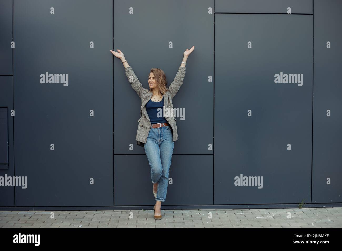 Full length photo of happy young businesswoman standing on one leg ...