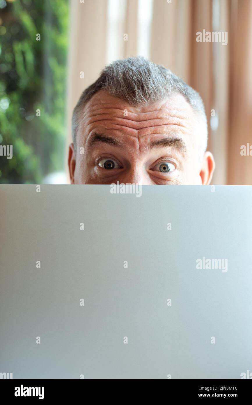 Closeup photo of cheerful mature businessman working with laptop ...