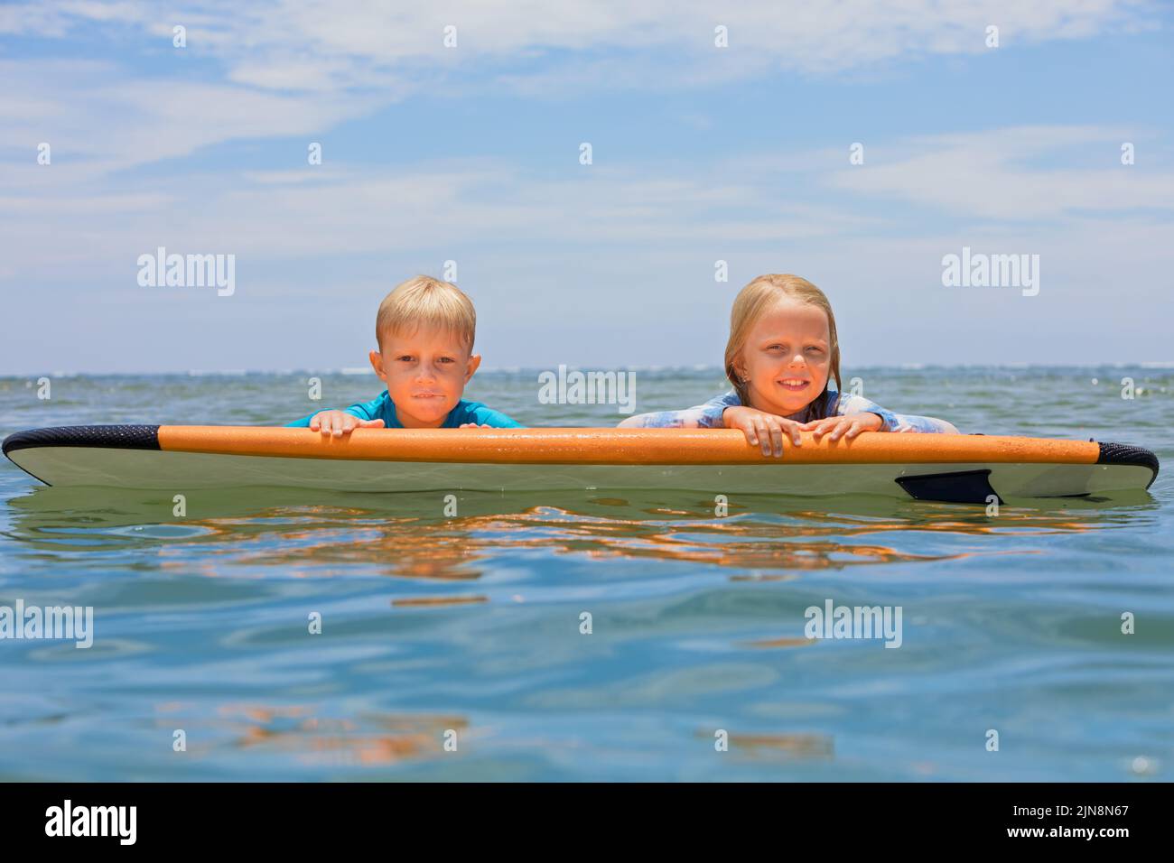 Boy and girl surfers hi-res stock photography and images - Alamy