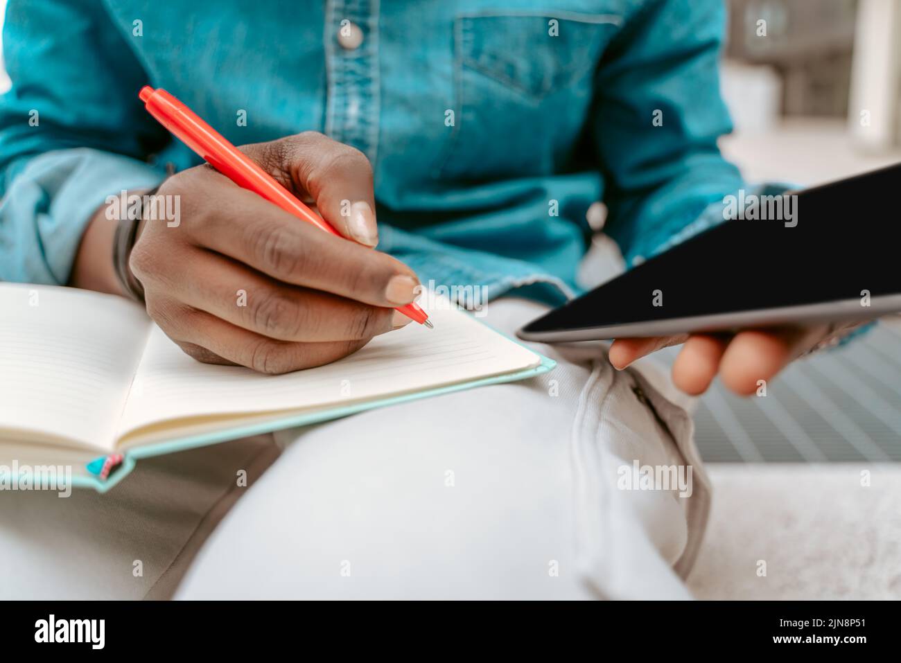 Hands writing with pen and holding tablet Stock Photo - Alamy
