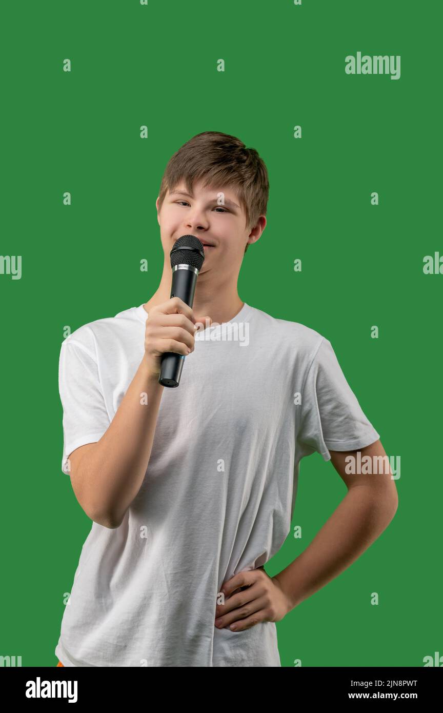 Smiling happy young singer performing a song Stock Photo - Alamy