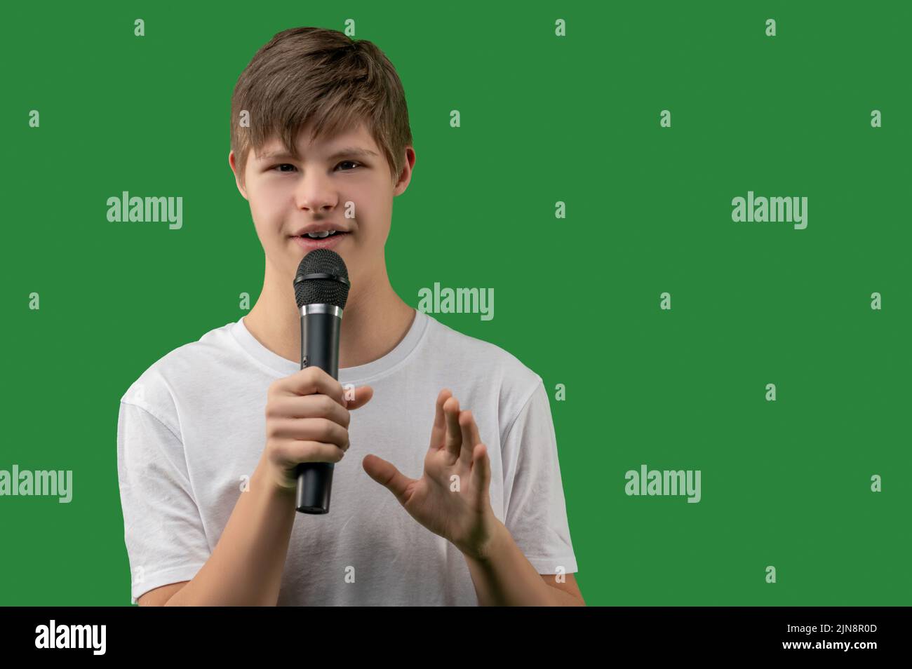 Young singer posing for the camera during the song performance Stock ...