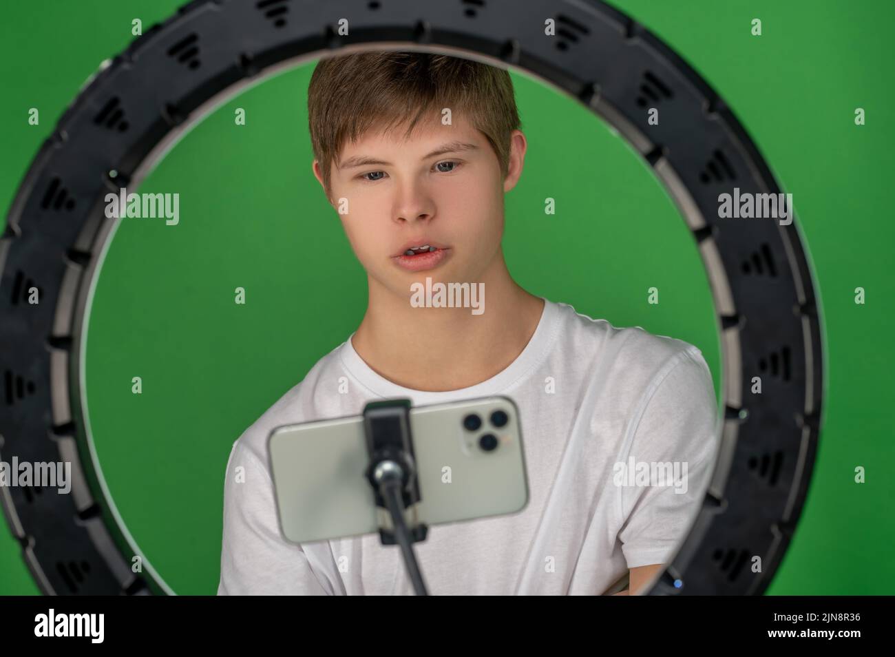 Teenager taking a selfie using a ring light Stock Photo - Alamy