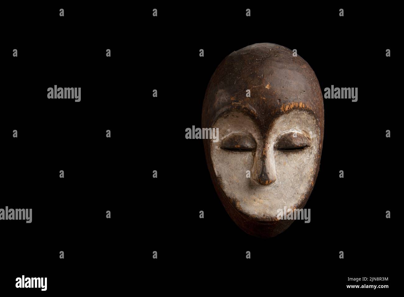 Traditional Gabonese wooden mask on a black background Stock Photo - Alamy