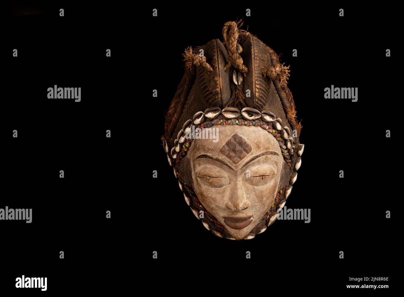 Traditional Gabonese funa wooden mask on a black background Stock Photo ...