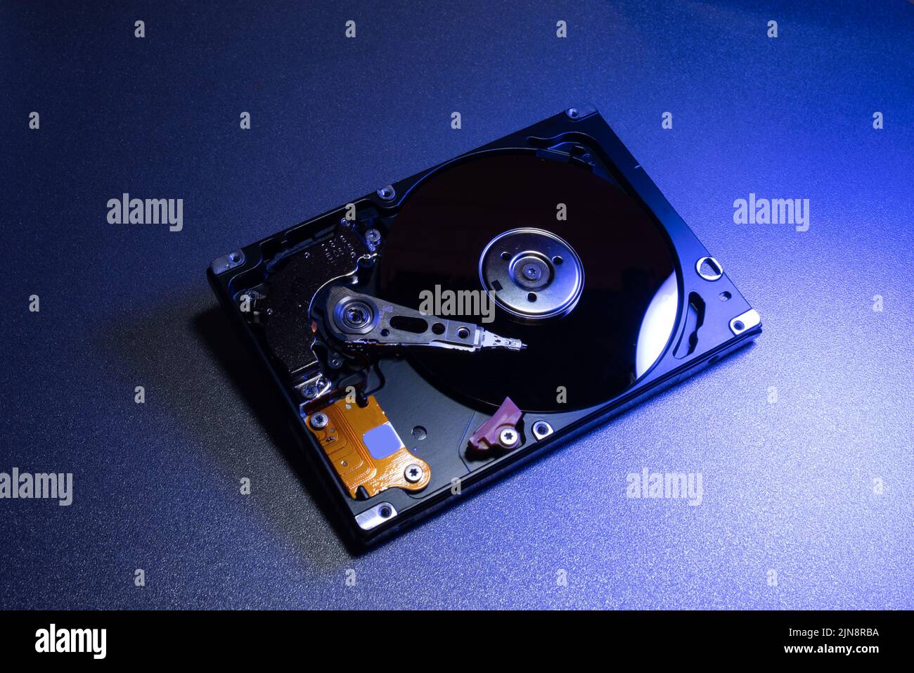 Close up of hard disk with blue background Stock Photo - Alamy