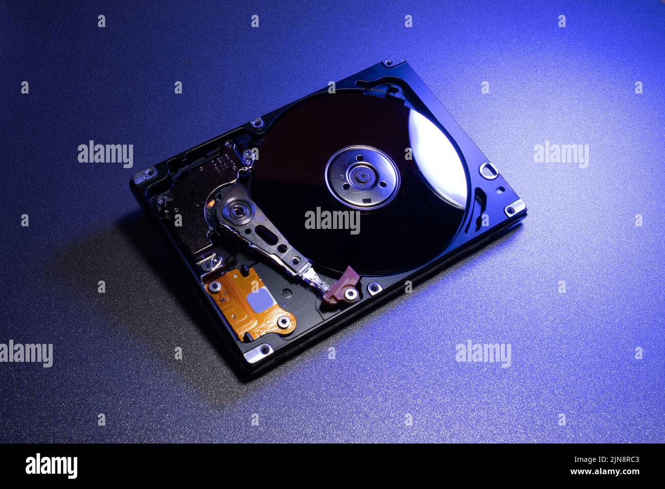 Close up of hard disk with blue background Stock Photo - Alamy