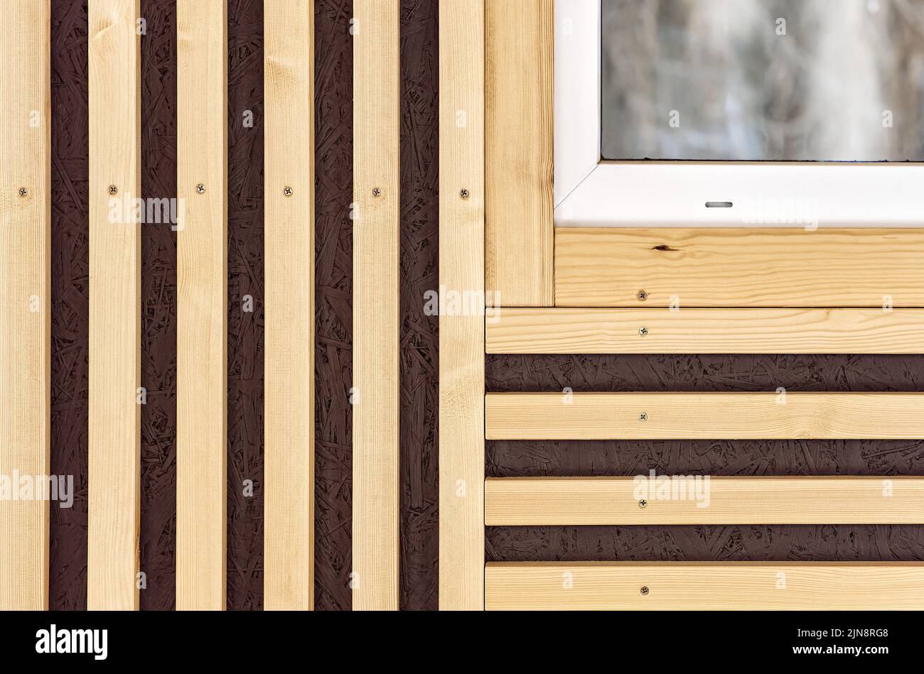 Building wall and window decorated with stylish wooden slats made of ...