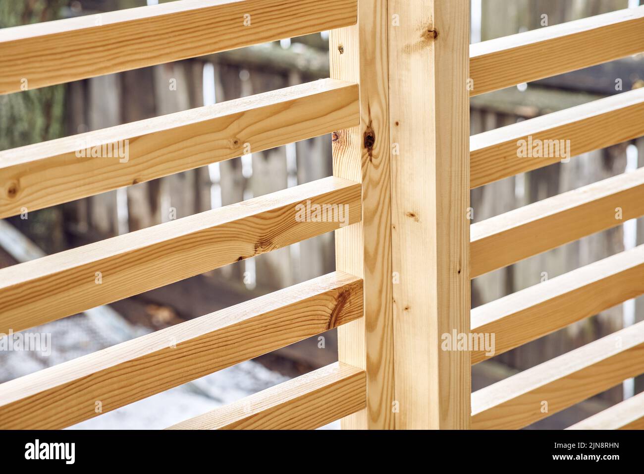 Stylish decorative partition wall made of thin wooden planks stands on ...