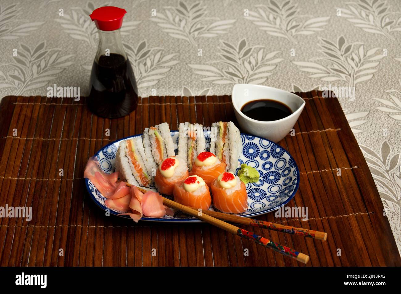 Sushi dish with of fashion sandwiches and Uramaki rolls served with ...