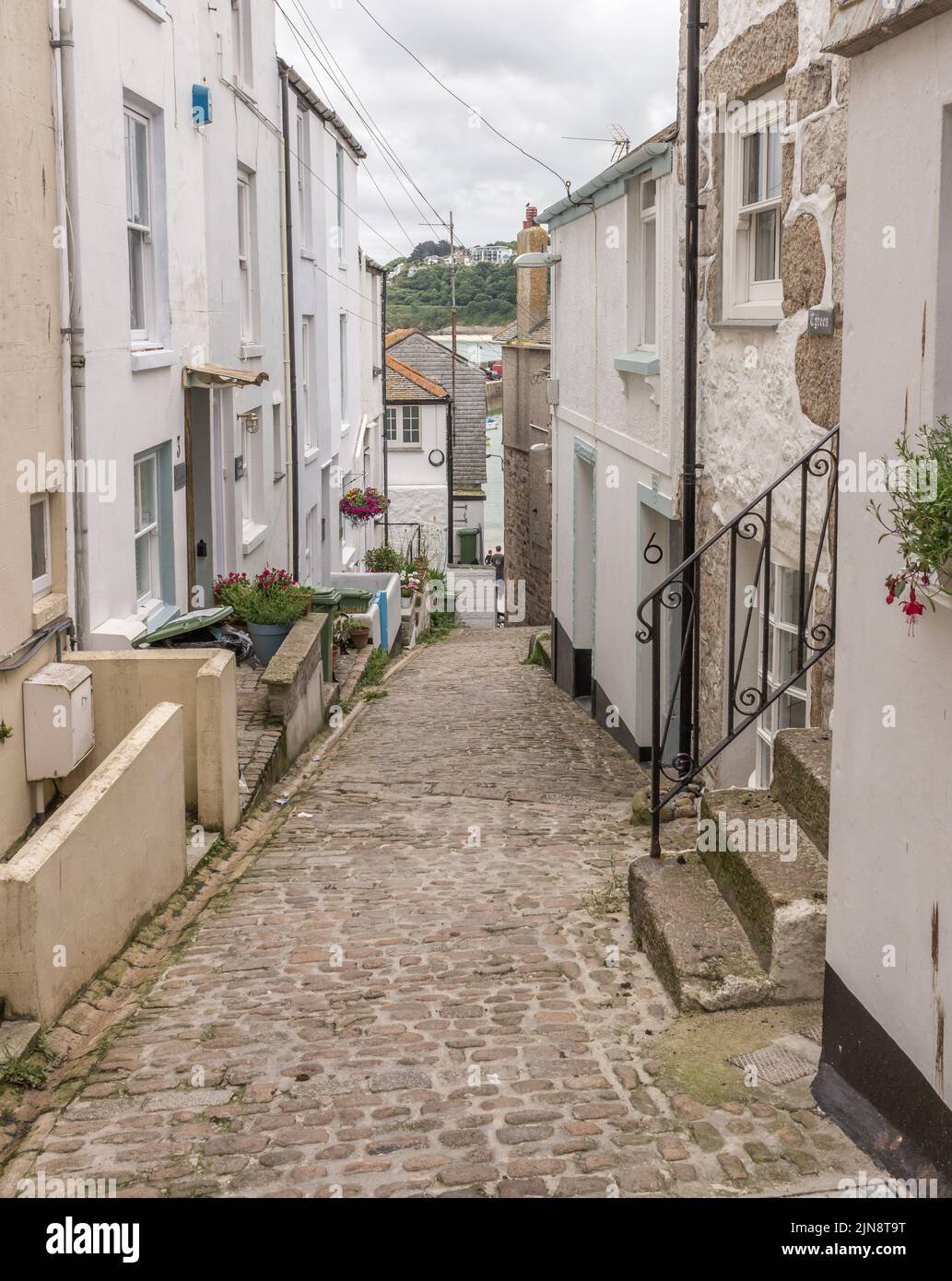 A narrow street with cozy white stone houses in St Ives, Cornwall, UK Stock Photo - Alamy