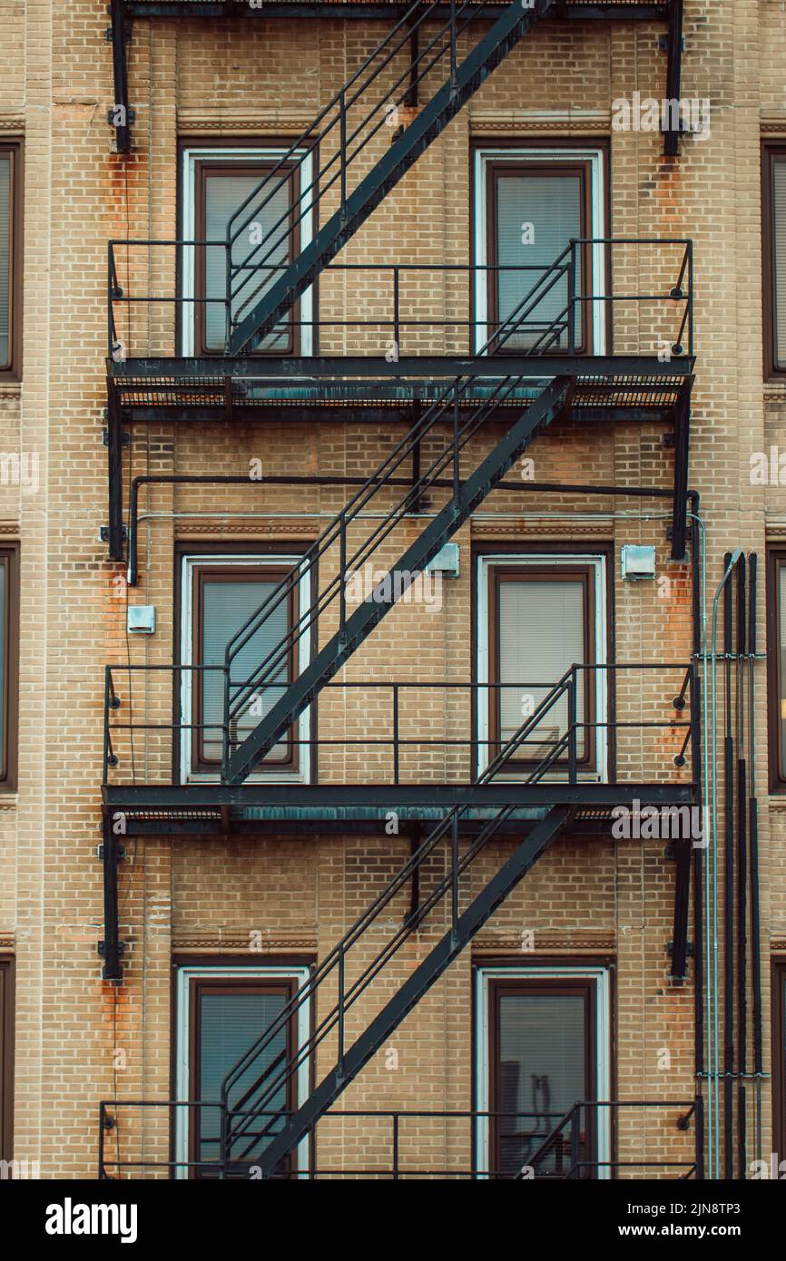 A closeup of a lovely building with fire escape ladders, a vertical ...