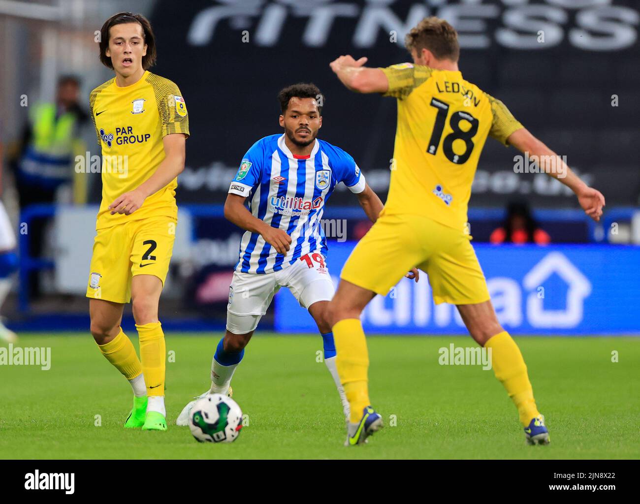 Duane Holmes #19 of Huddersfield Town goes in to tackle Ryan Ledson #18 ...