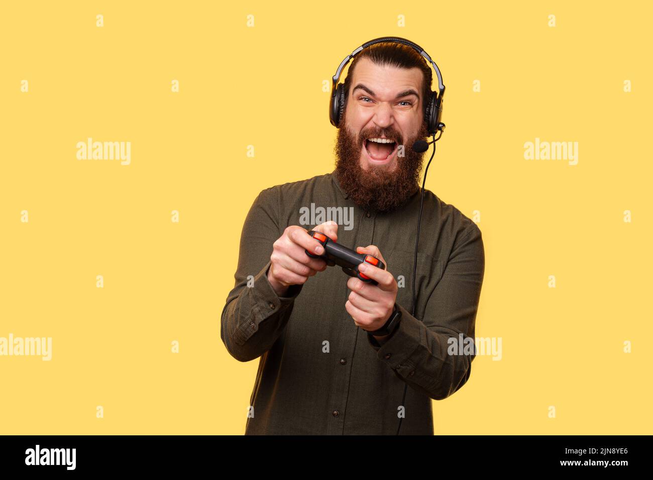 A picture of a young bearded gamer playing with his new console Stock ...