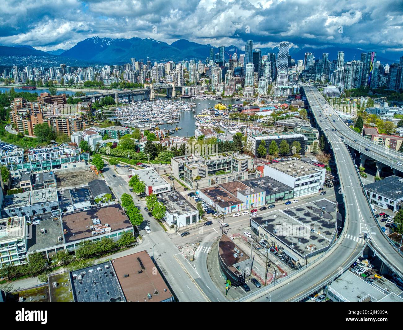 An aerial view of cityscape Vancouver surrounded by buildings and trees ...