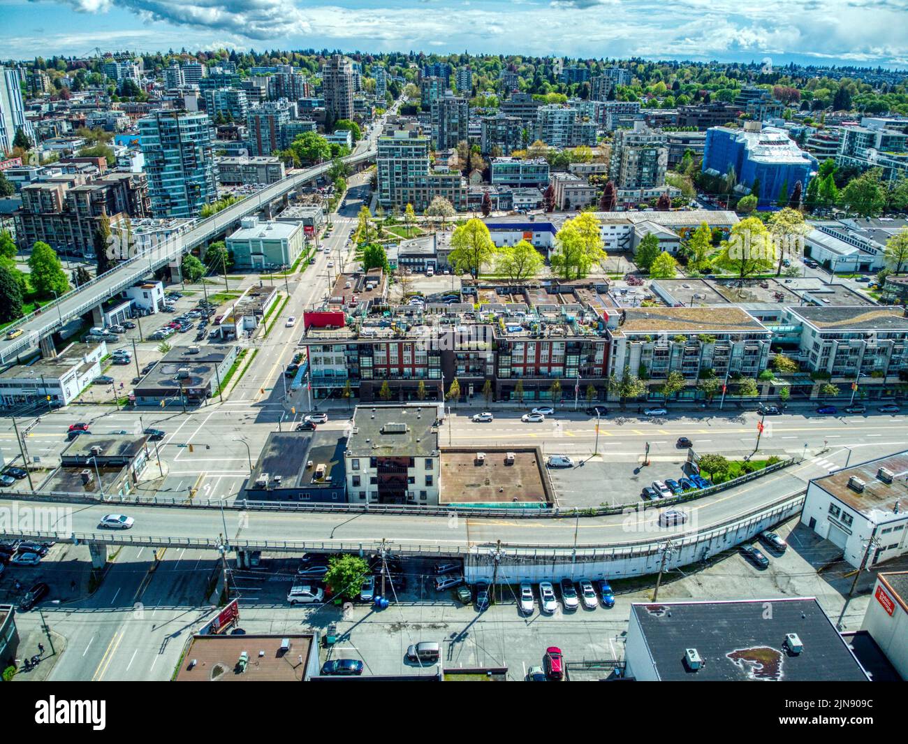 An aerial view of cityscape Vancouver surrounded by buildings and trees ...