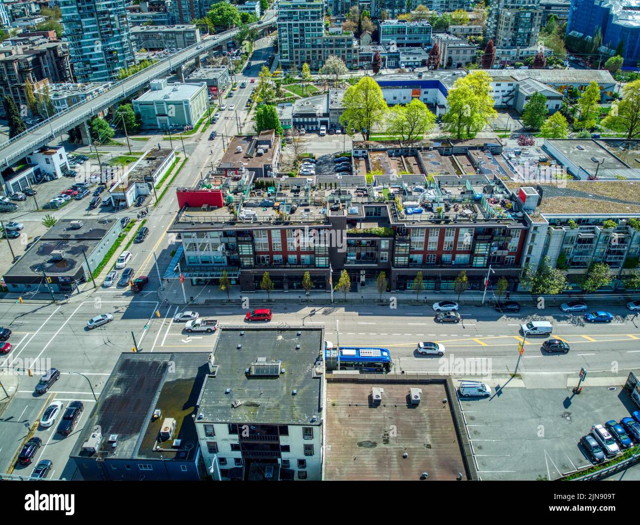 An aerial view of cityscape Vancouver surrounded by buildings and trees ...