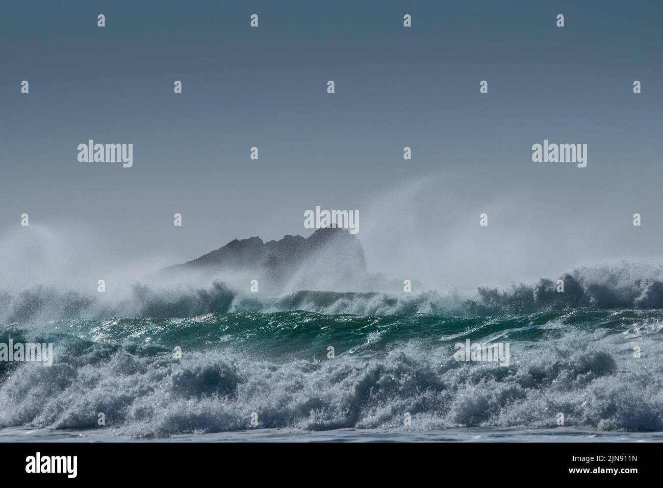 Strong wind blowing spray off breaking waves In Fistral Bay in Newquay ...